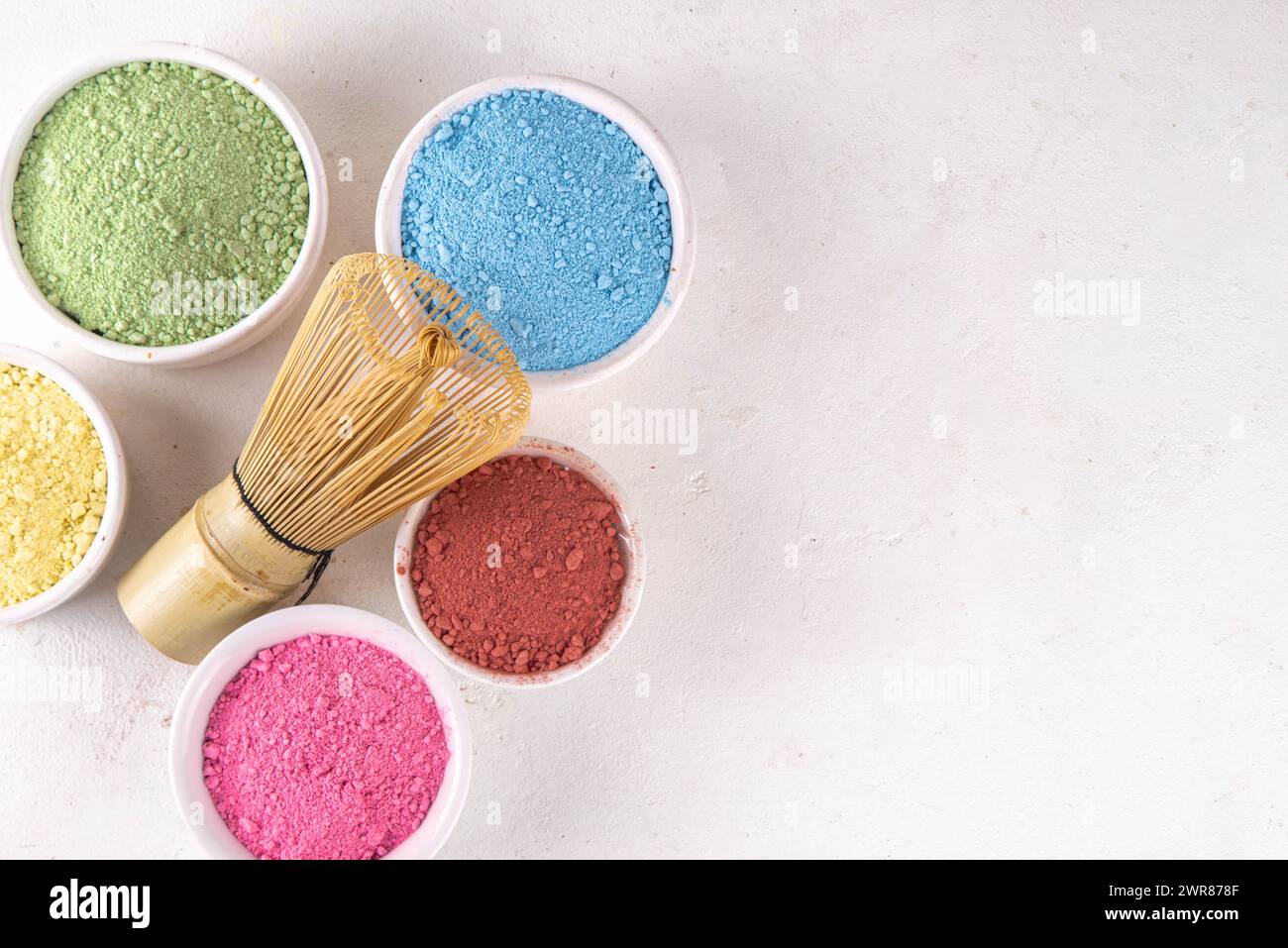 Set of dried plant matcha powder in white bowl. Various color and ...