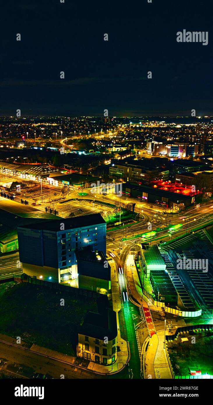 Vertical aerial view of a city at night with illuminated streets and ...