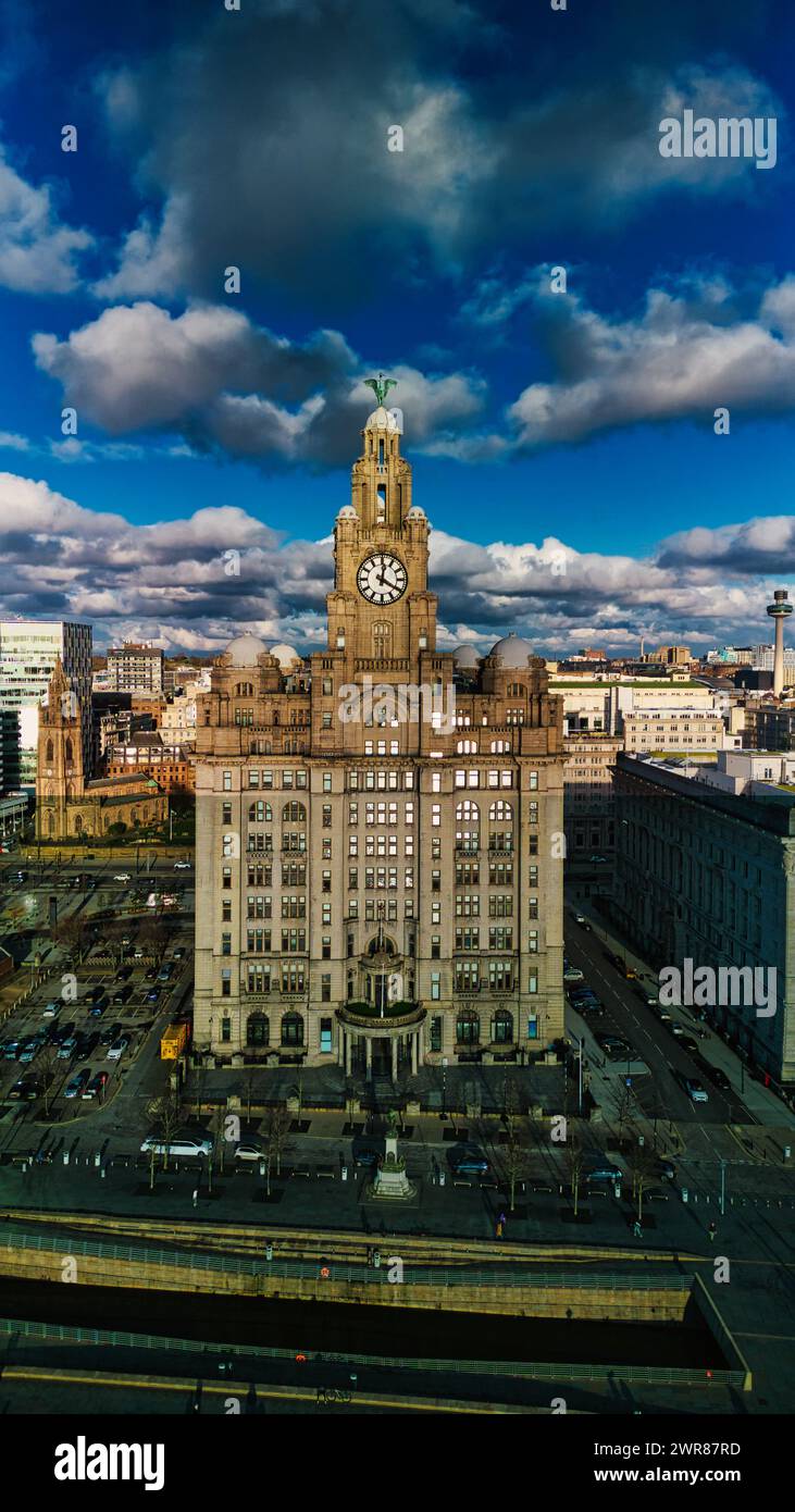 Dramatic sky over historic clock tower building in urban landscape in ...
