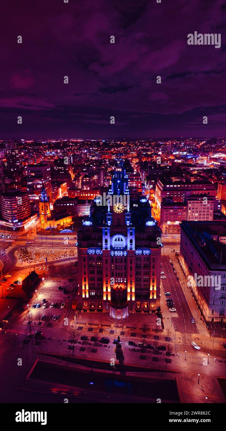 Aerial night view of a cityscape with illuminated buildings under a ...