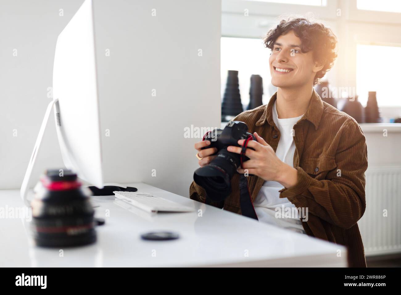 Happy male photographer reviewing images on DSLR camera Stock Photo - Alamy