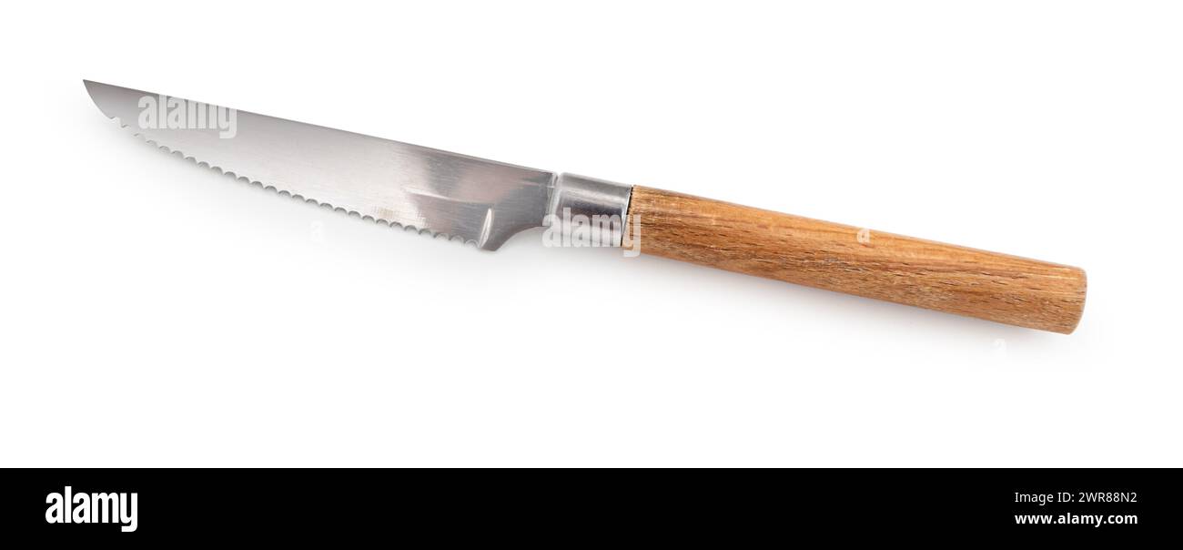 A used jagged meat cutting knife with a wooden handle isolated on white ...