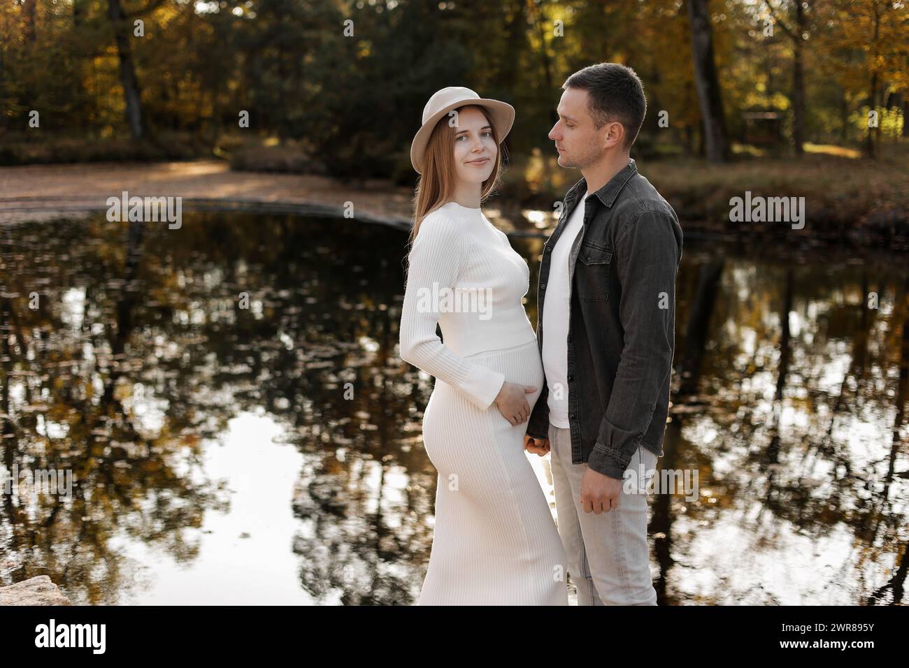 Family day. Stylish marriage pregnant couple waiting for baby. Man is ...