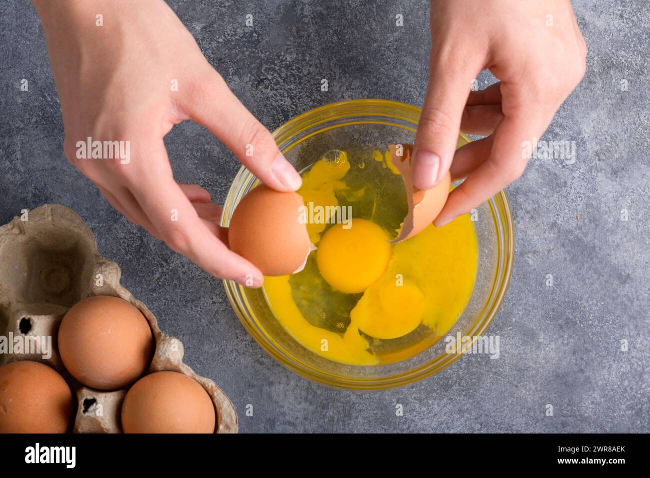 Hand dropping egg hi-res stock photography and images - Alamy