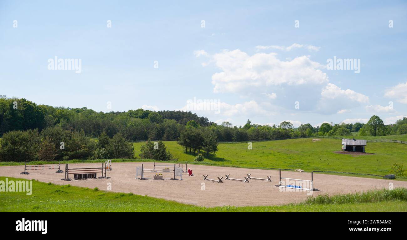 outdoor riding ring with show jumping jumps set up in open field blue ...