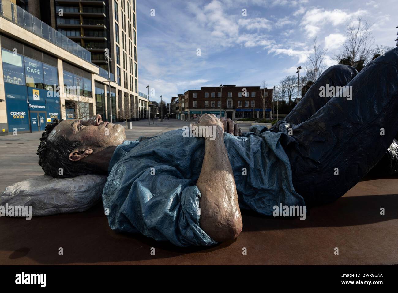 'Lying man' sculpture in Woking town centre, in Surrey, England, which ...
