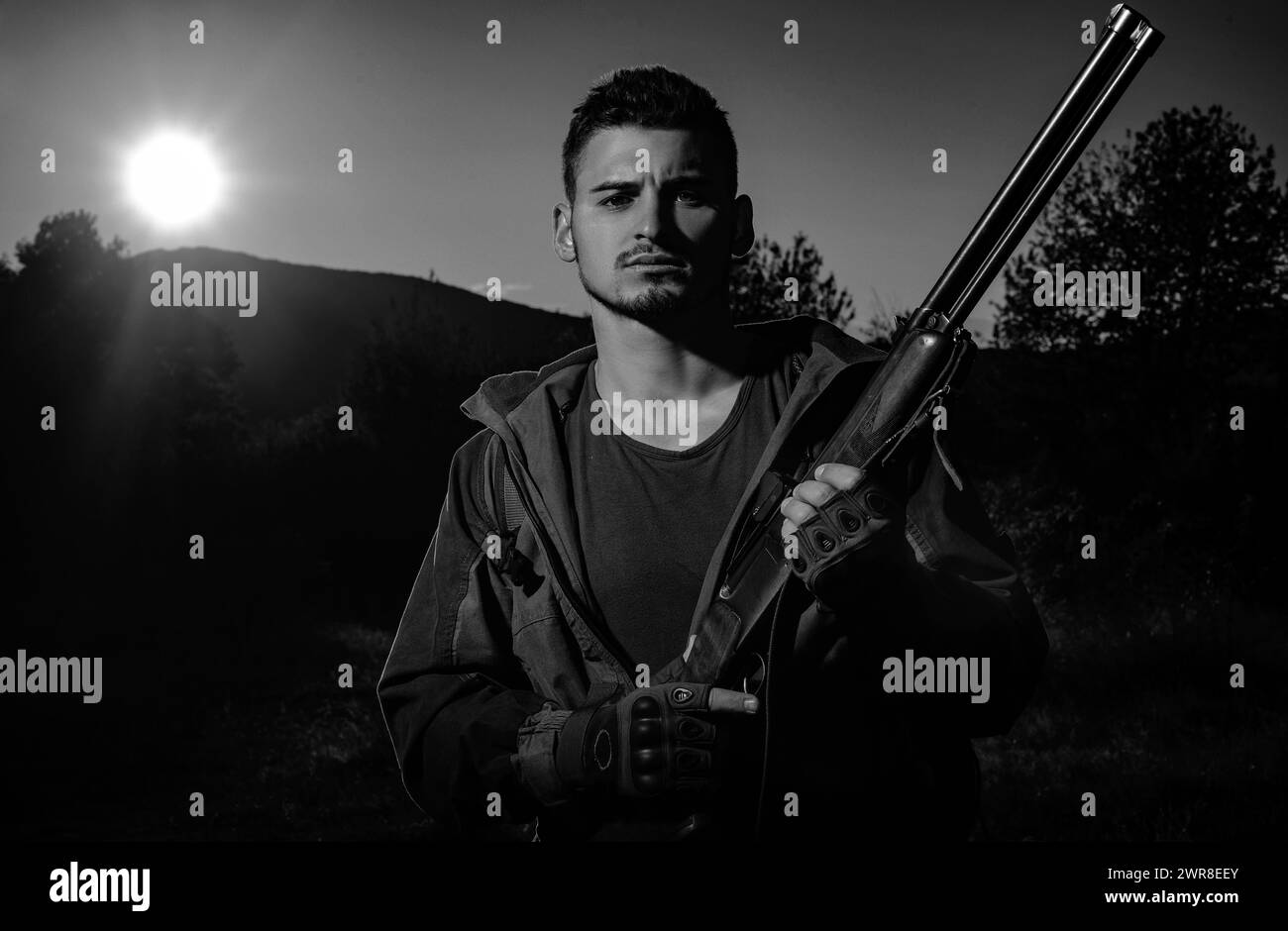 Hunter with Powerful Rifle with Scope Spotting Animals. Rifle Hunter ...