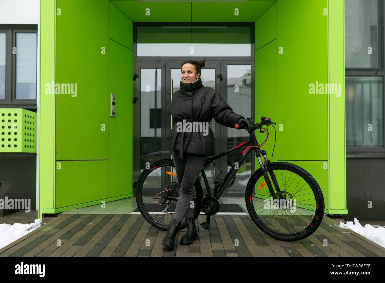 Sports concept, young woman walking on a day off while riding a bike ...