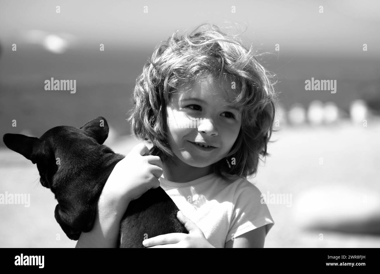 Kids playing with puppy Black and White Stock Photos & Images - Alamy