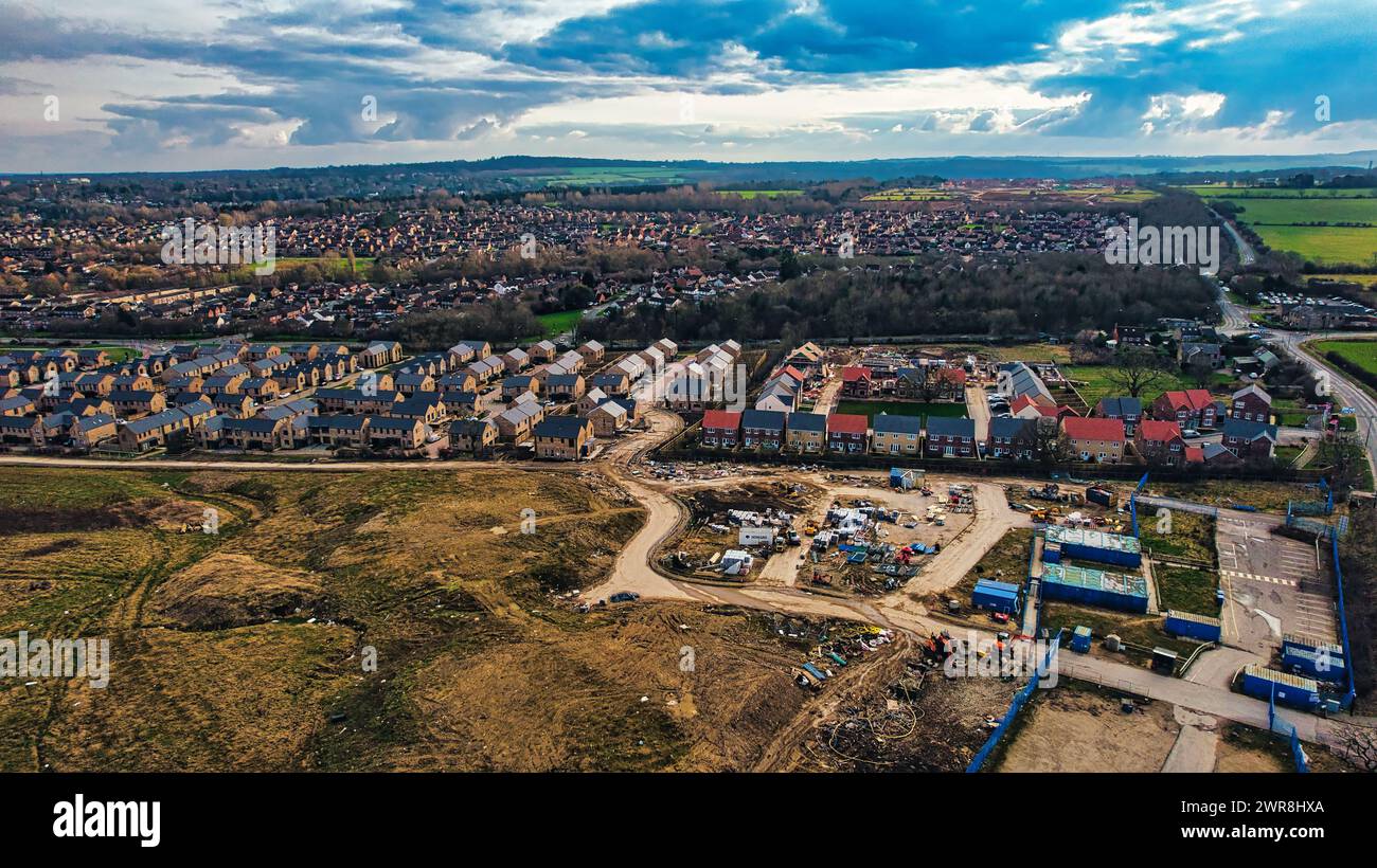 Aerial view of a suburban development with houses and roads, showcasing ...
