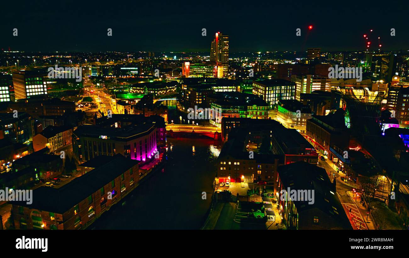 Aerial night view of a vibrant cityscape with illuminated buildings and ...