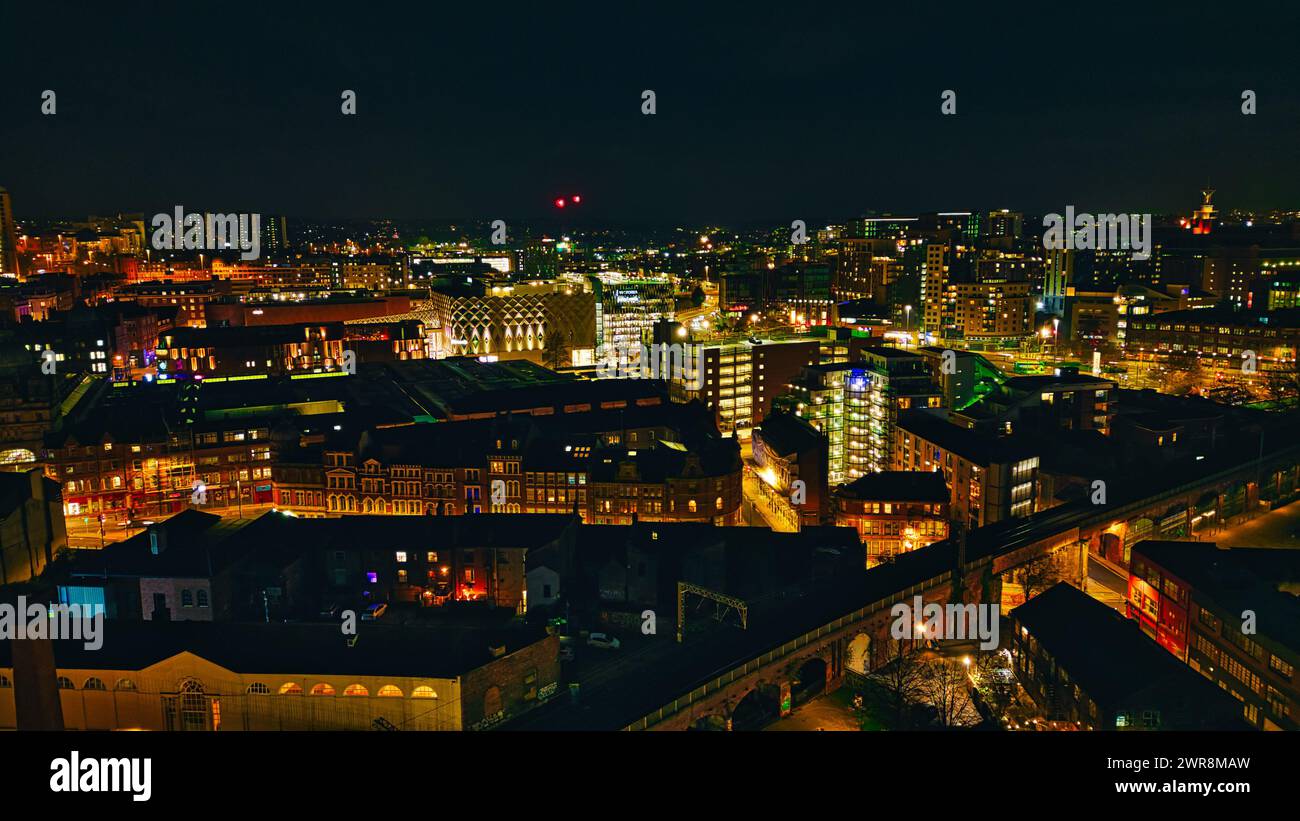 Night cityscape with illuminated buildings and streets, showcasing ...