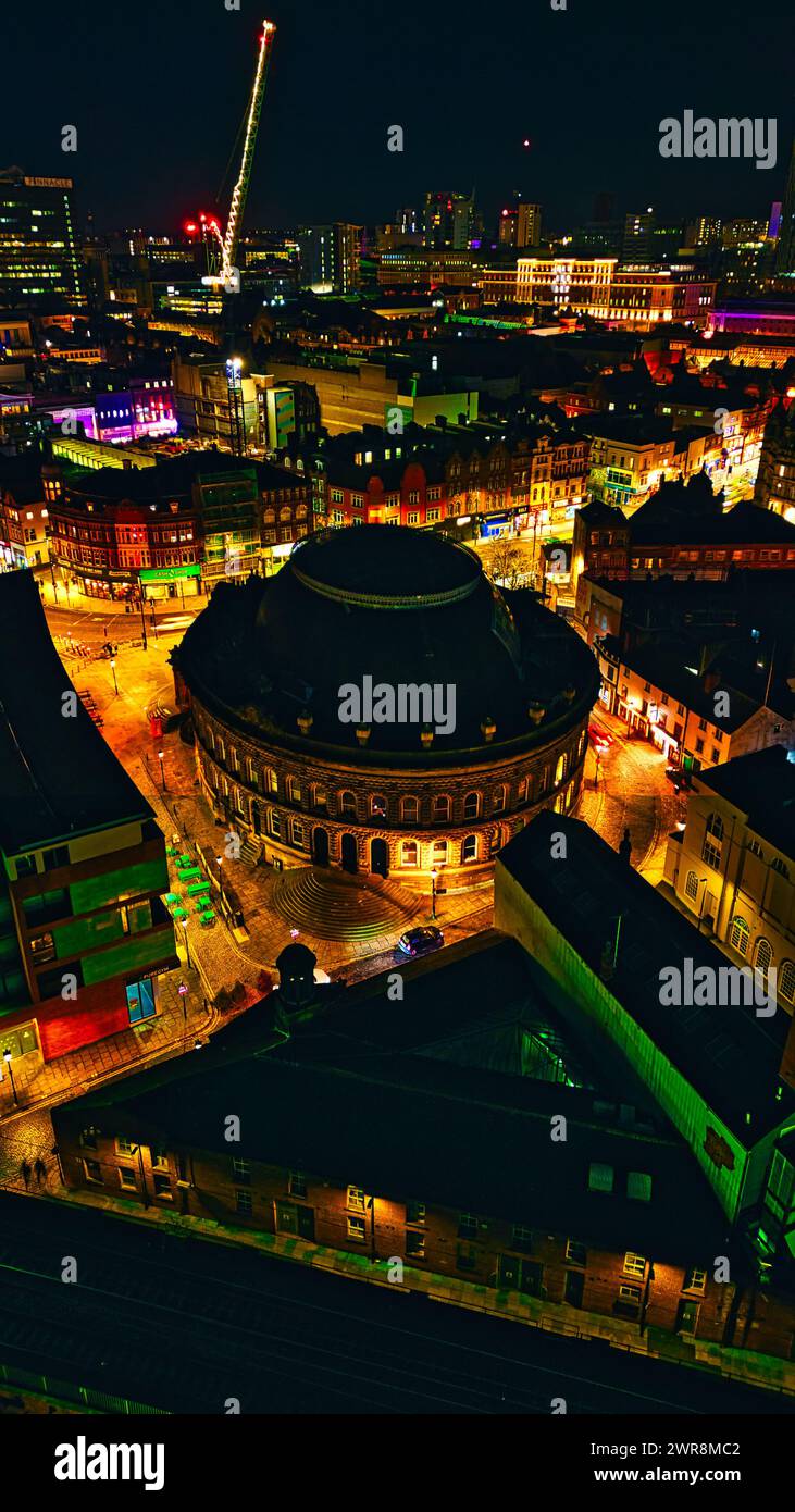 Aerial night view of a cityscape with illuminated streets and a ...