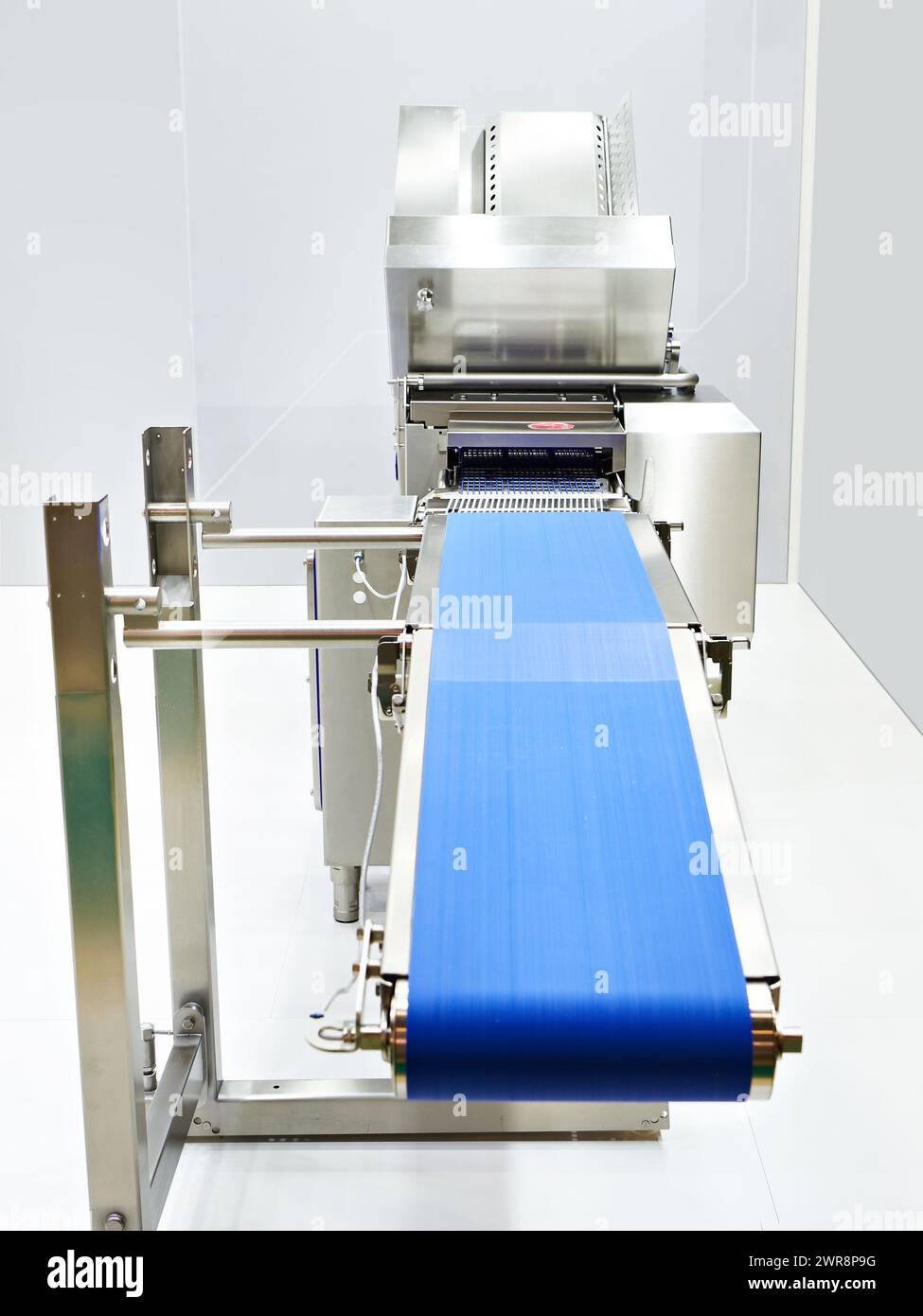 Conveyor belt skinning machine for food production Stock Photo - Alamy