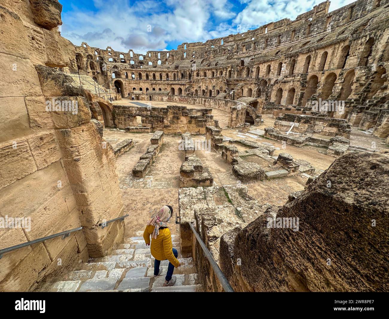 A foreign tourist descends into the interior of the Roman amphitheatre ...