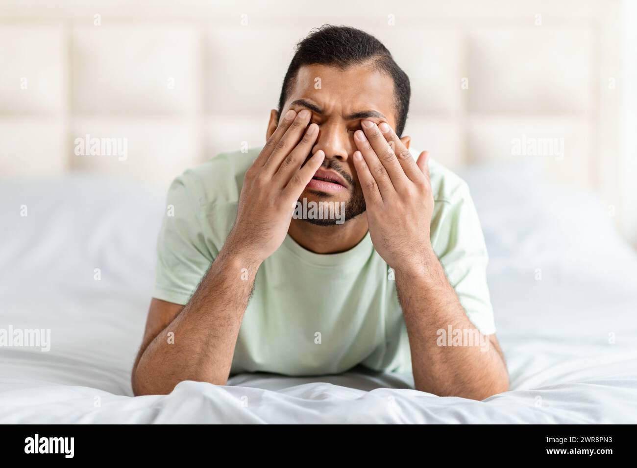 Upset broken african american young man crying in bed Stock Photo - Alamy