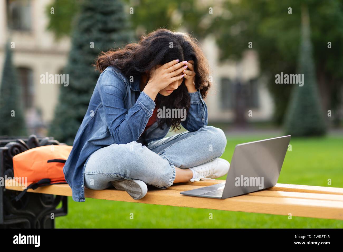 Stressed young Indian woman student studying with laptop Stock Photo ...