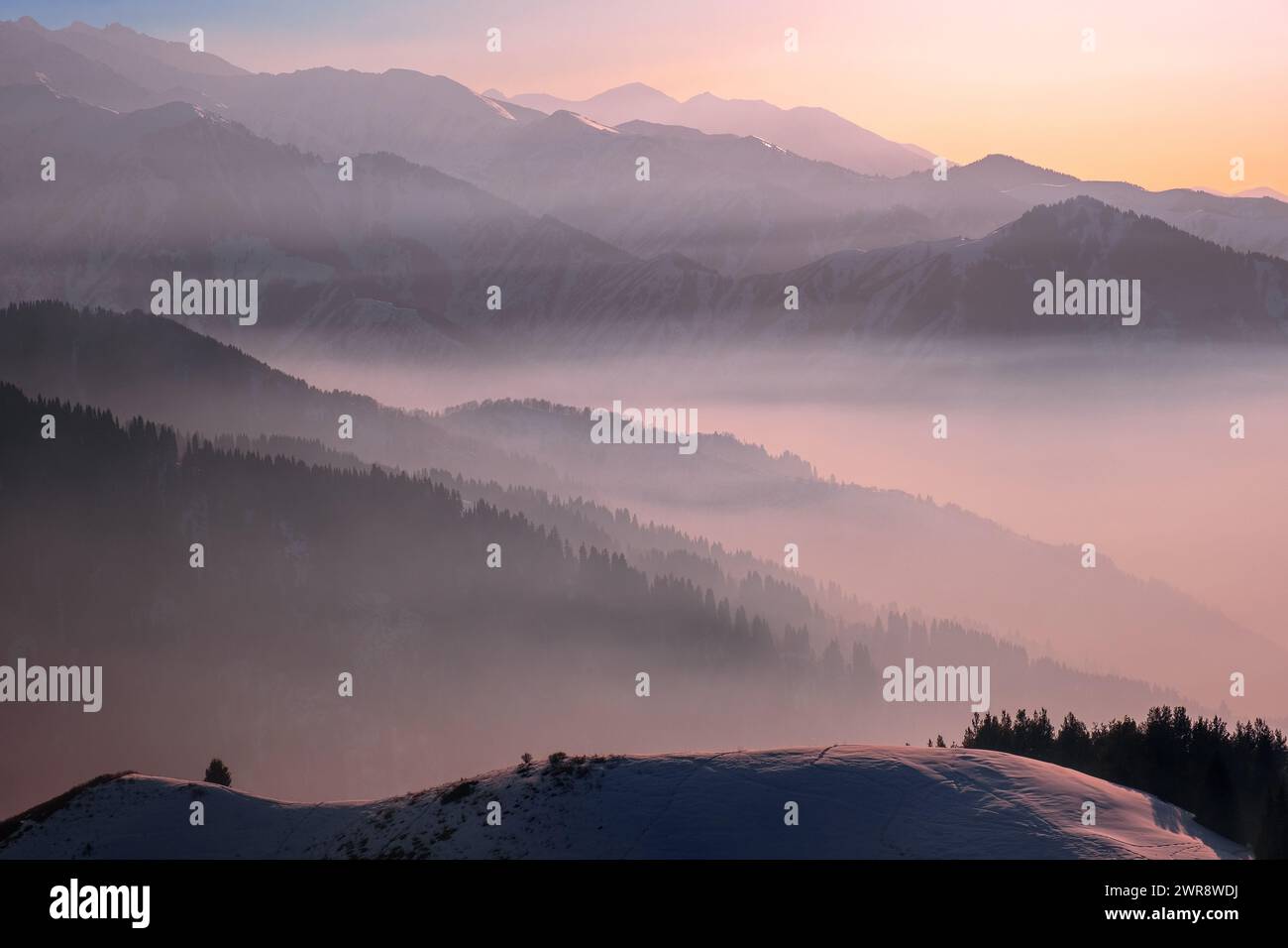 Mountain valley shrouded in a light haze on the eve of sunset Stock ...