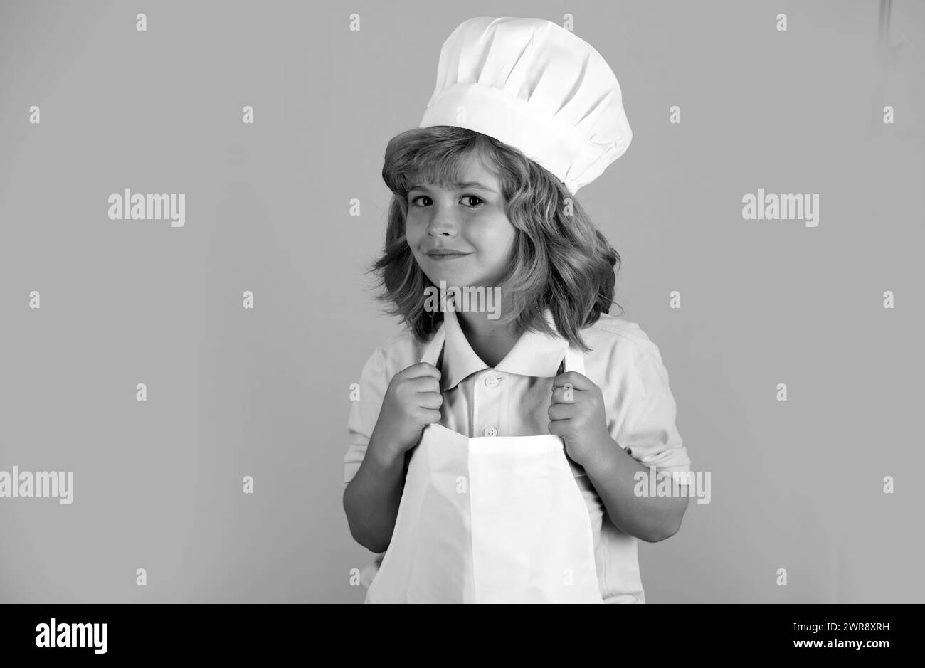 Chef kid boy making fresh vegetables for healthy eat. Portrait of ...