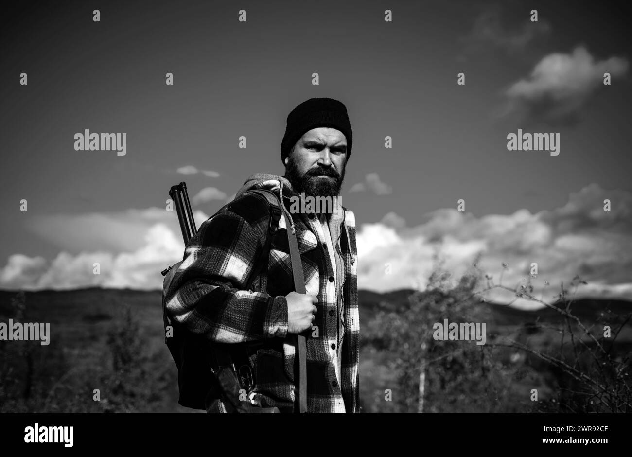 Hunter with shotgun gun on hunt. Bearded hunter man holding gun and ...