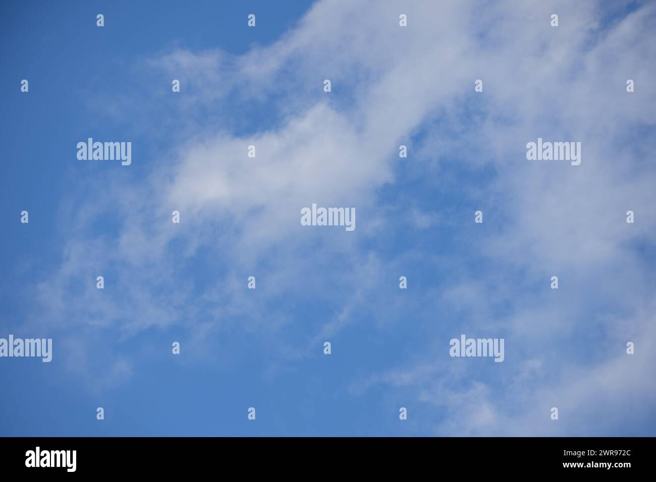 A blue sky landscape with some diffuse clouds Stock Photo - Alamy