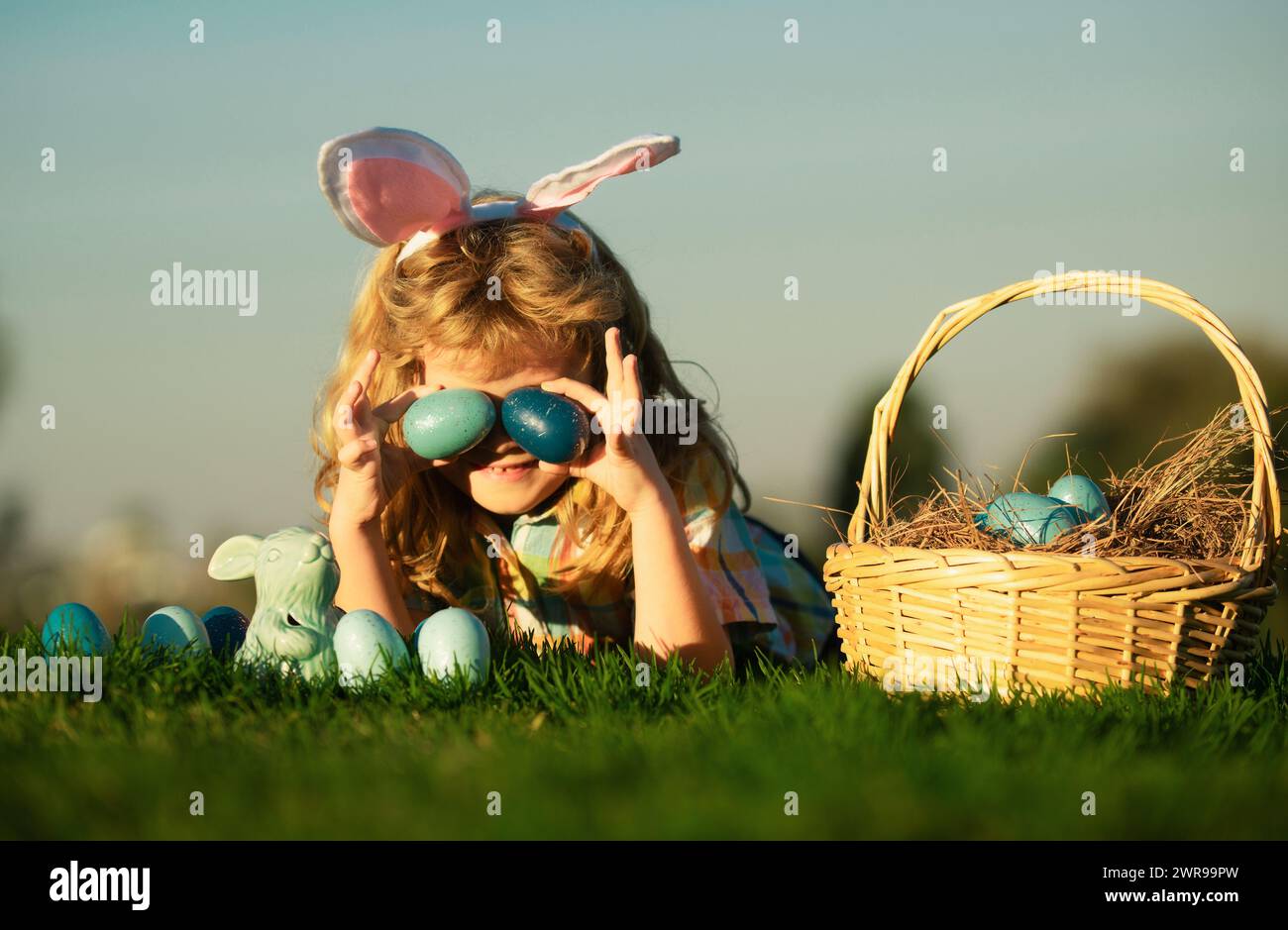 Easter egg hunt in garden. Children playing in field, hunting easter ...