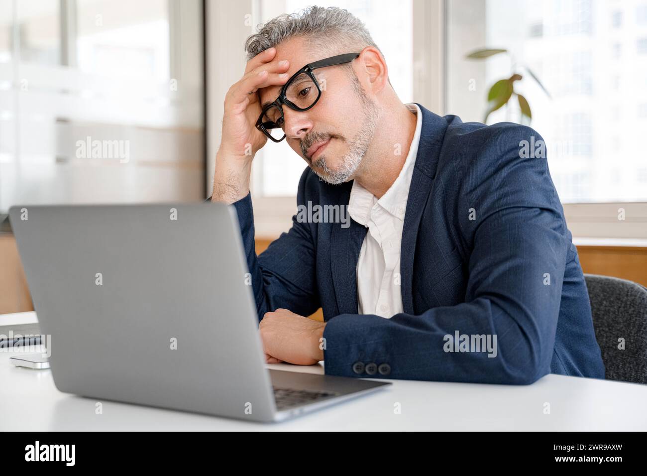 Fatigued mature businessman using laptop for working, man in formal ...
