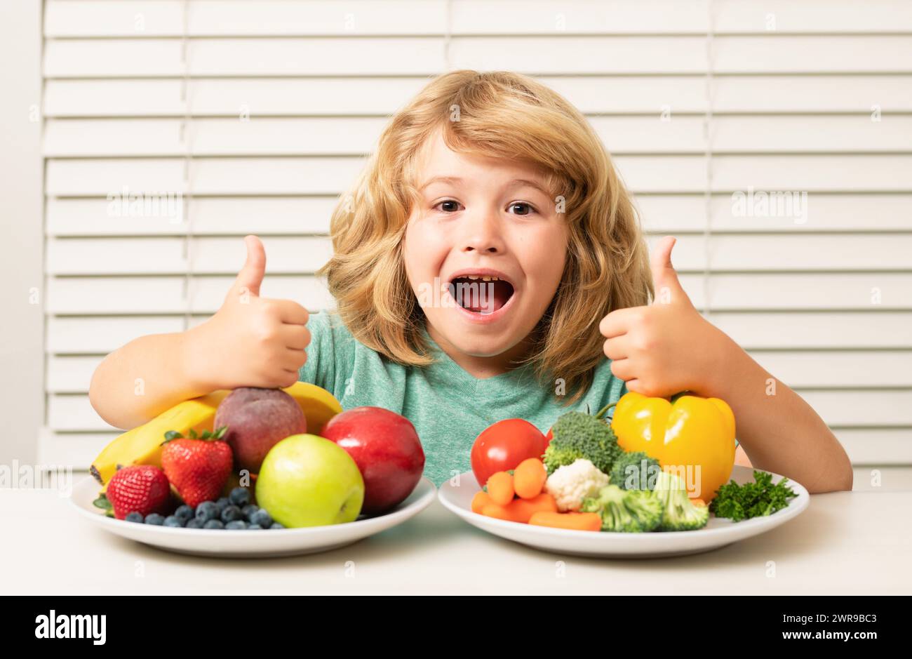 Fruits and vegetables. Kid boy eating healthy food vegetables ...