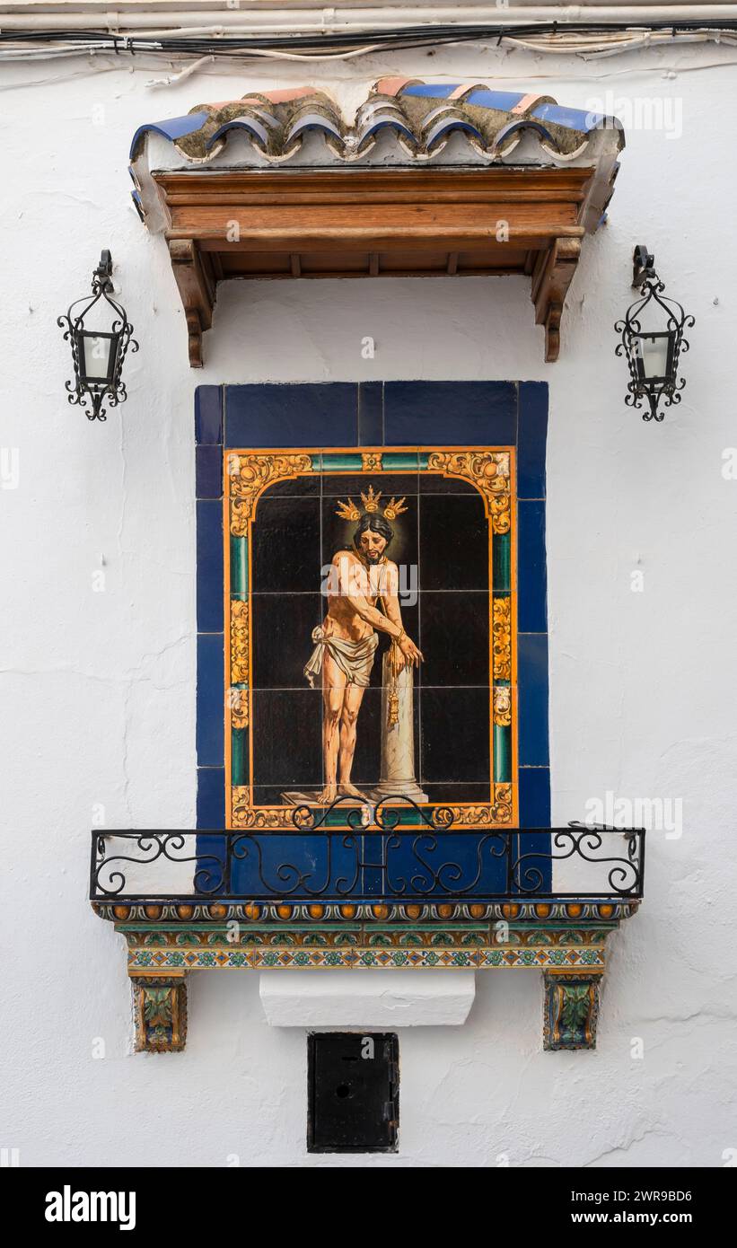 Statue mounted on exterior wall with stained glass backdrop Stock Photo ...