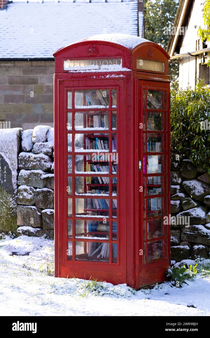 31/03/22 Snow covers an old red phone-box which has been converted into ...