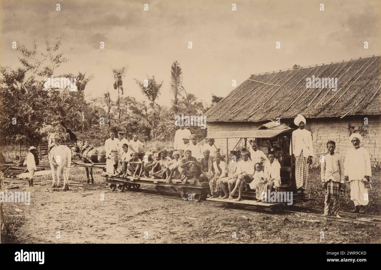 Group of people on carts on rails pulled by horses, in Lau-Boentoe ...
