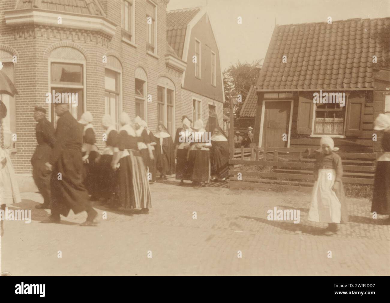 Churchgoers in Volendam, Men and women in traditional costumes in ...