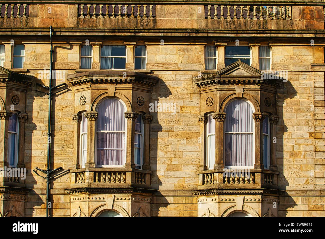 Close-up of a classic sandstone building facade with ornate windows and ...