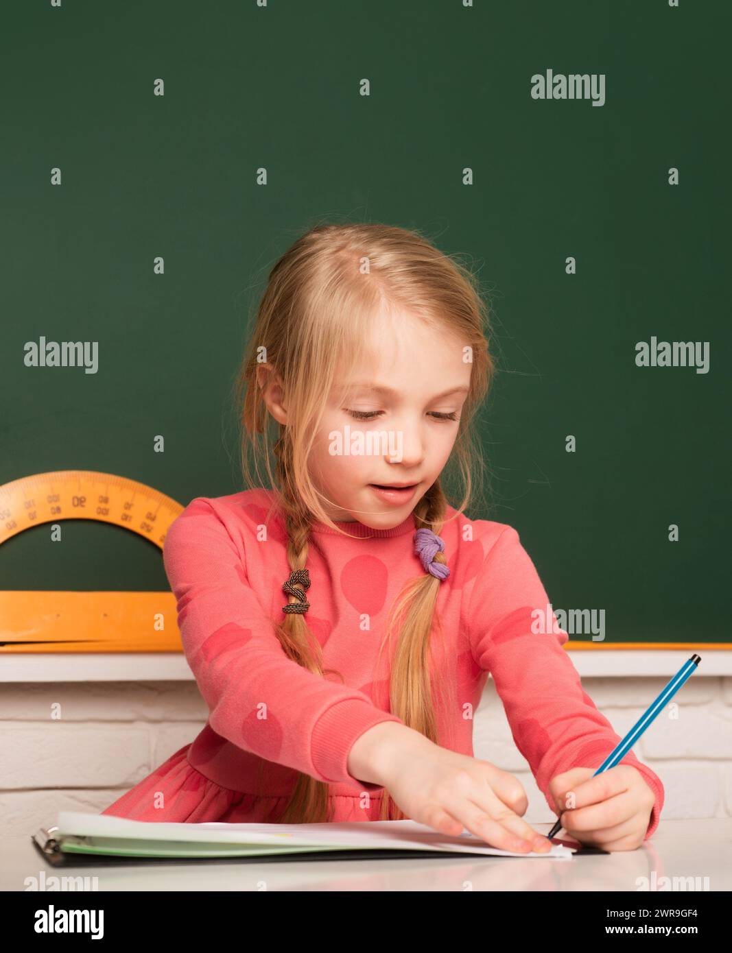 School concept. Kids drawing in notepad. Little girl pupil study in ...