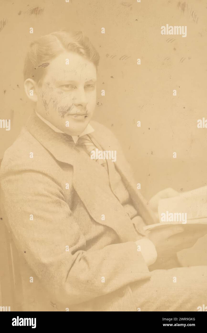 Portrait of a seated man with open book in hand, This photo is part of ...