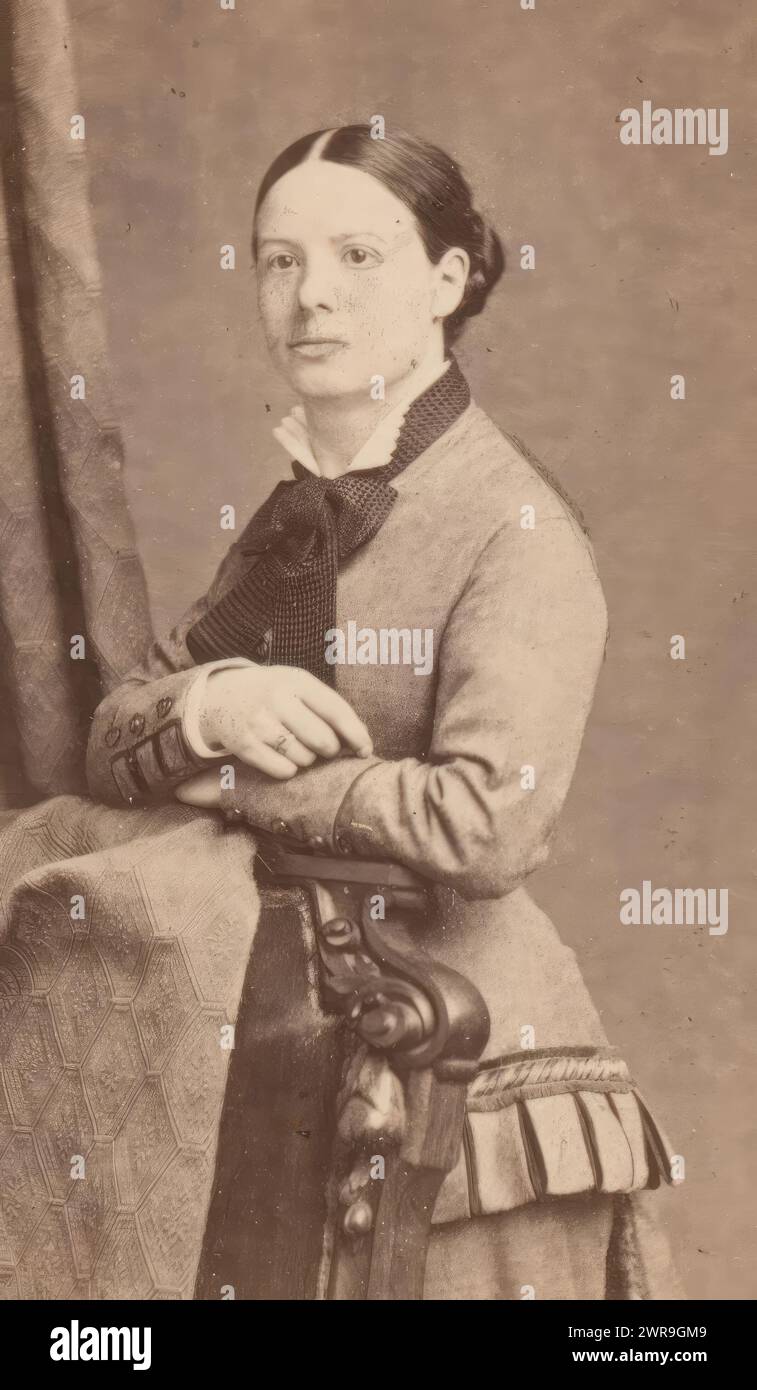 Portrait of a standing girl, leaning on the back of a chair, This photo ...