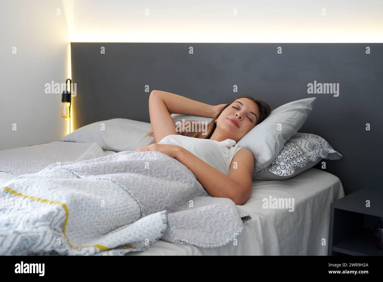 Young woman sleeping well in bed. Teenager girl has good night sleep ...
