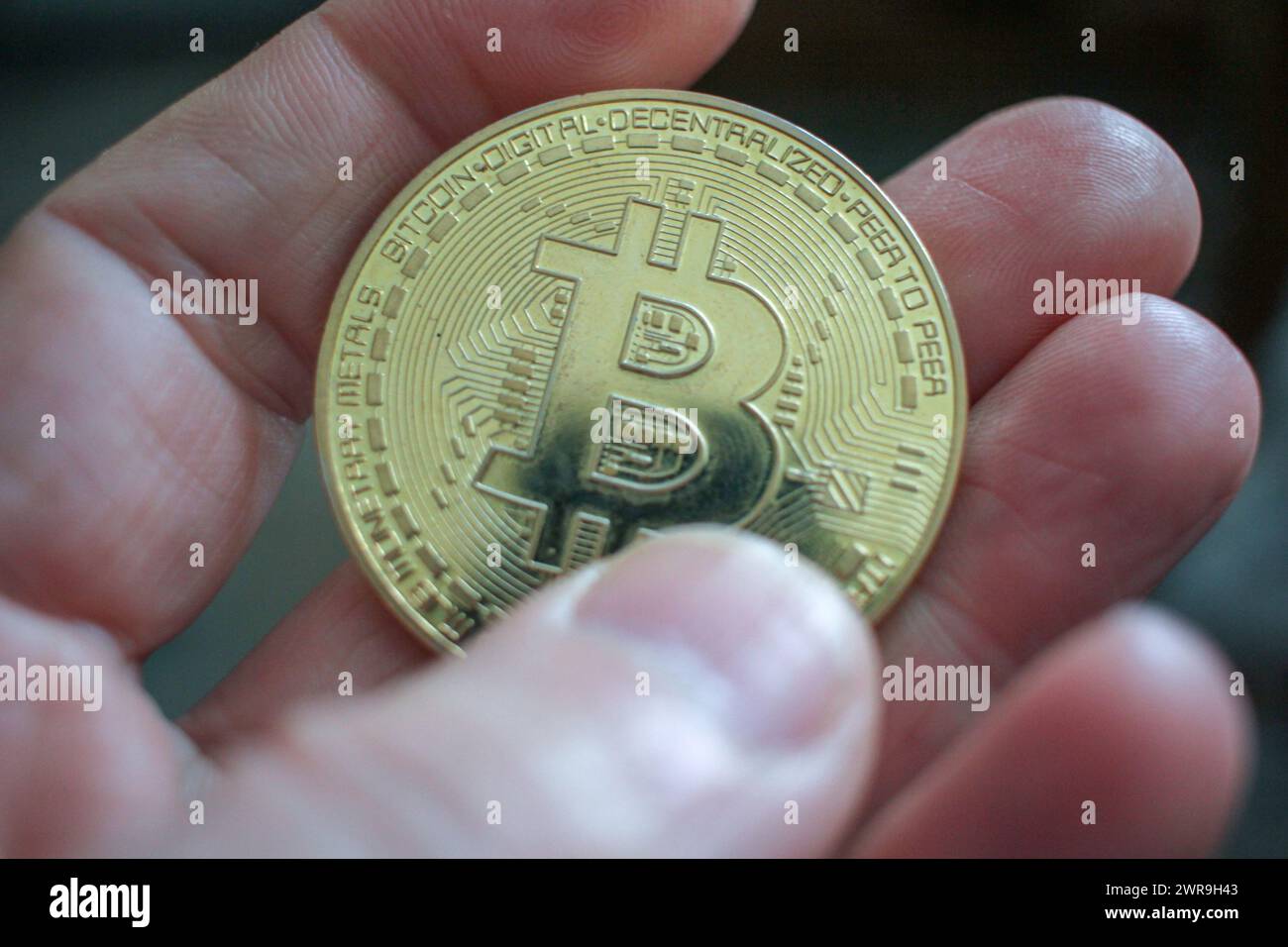 touching a physical representation of a bitcoin, the digital money ...