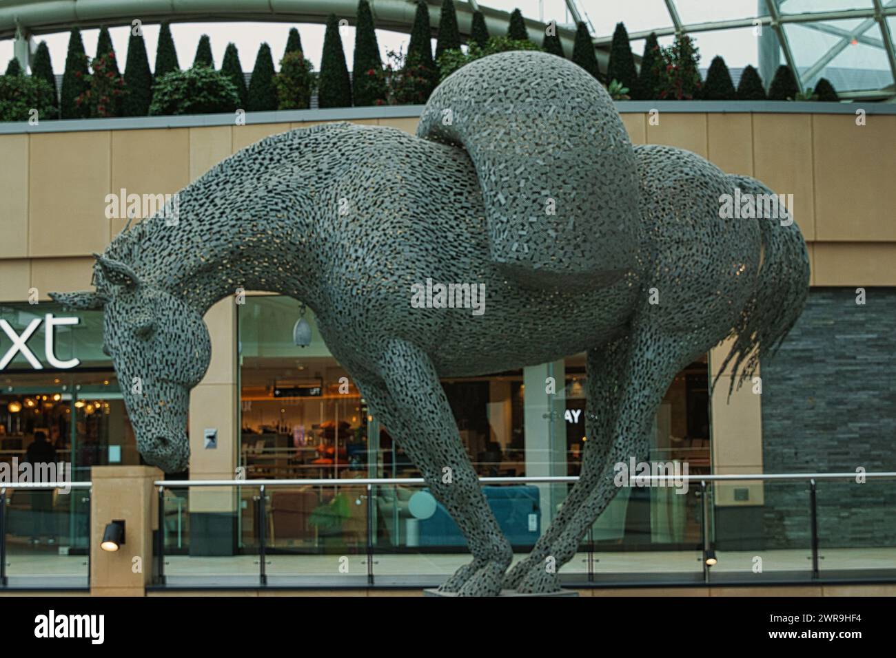Large metal horse sculpture at a shopping center, showcasing modern art ...