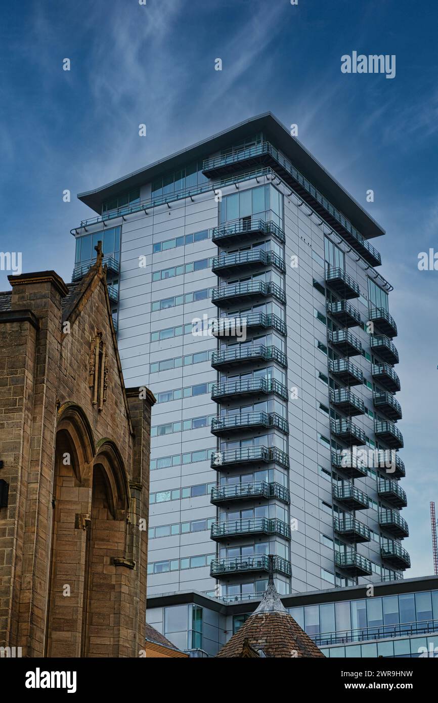 Contrast of old and new architecture with a modern glass skyscraper ...