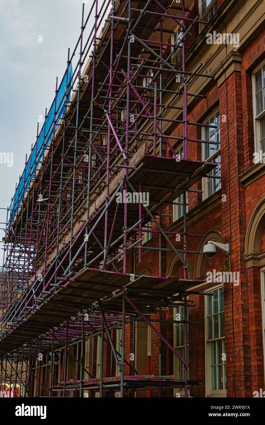 Scaffolding structure on the exterior of a brick building, indicating ...