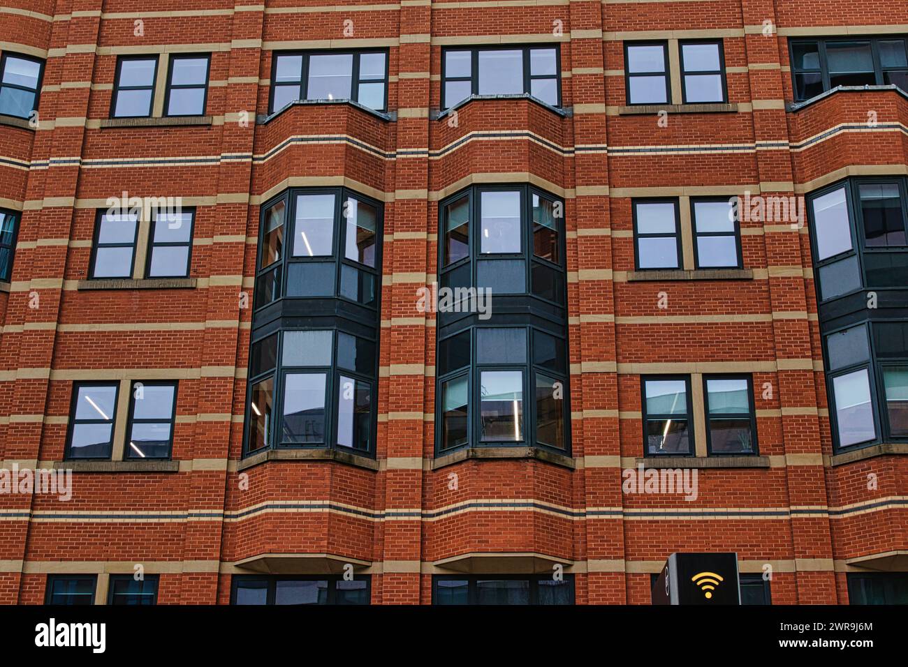 Modern brick building facade with patterned windows and architectural ...
