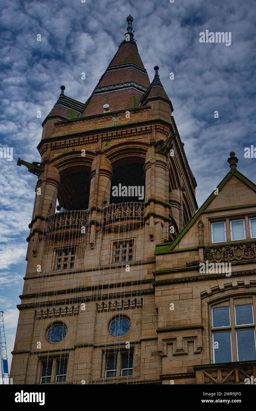 Victorian architecture with a detailed tower under a cloudy sky in ...