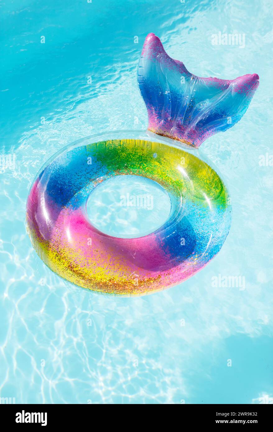 Rainbow mermaid inflatable ring in swimming pool Stock Photo - Alamy