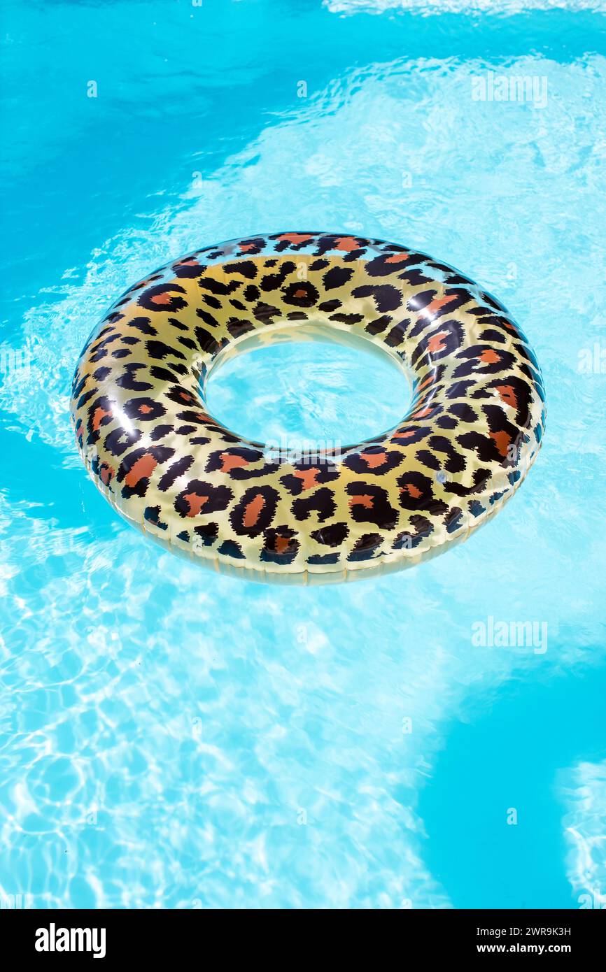 Inflatable leopard ring in swimming pool Stock Photo - Alamy