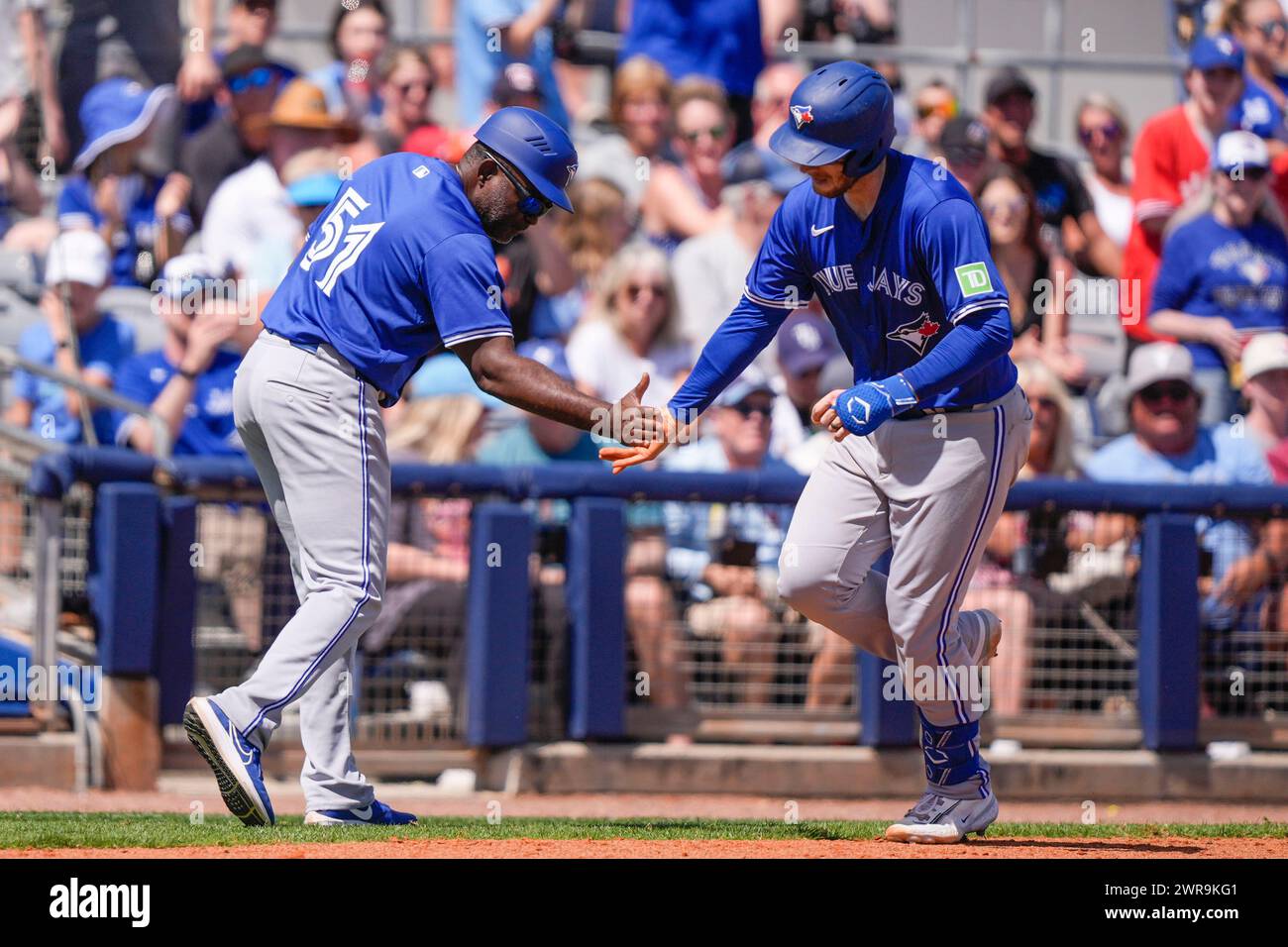 Toronto Blue Jays Danny Jansen is greeted by third base coach Carlos ...