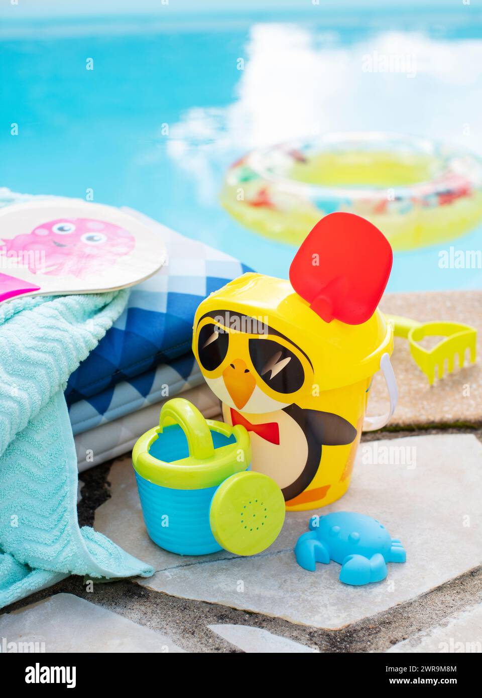 Plastic bucket on the edge of a swimming pool Stock Photo - Alamy