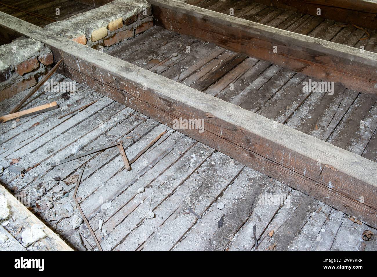 Renovation of an old attic with a wooden floorboard and wooden beams ...