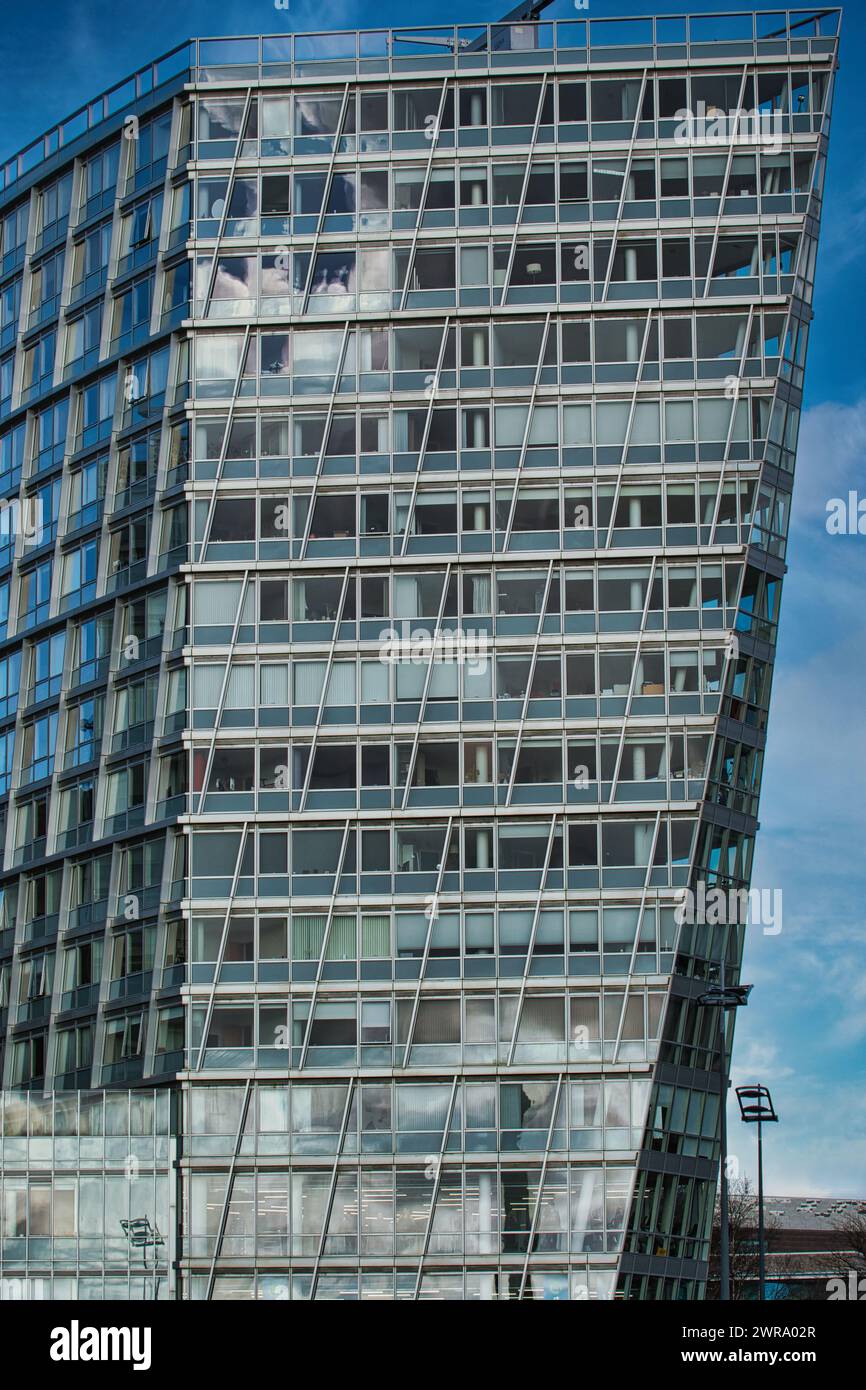 Modern office building under construction with scaffolding against a ...