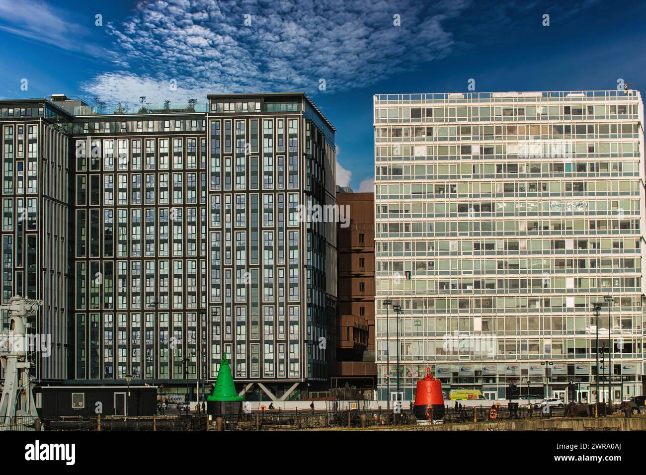 Modern office buildings with reflective glass facades under a blue sky ...